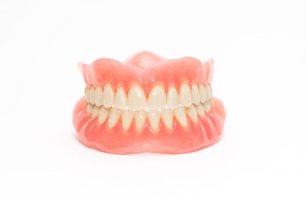 Two acrylic dentures ,white background. - Dr. Mark R. Simeone